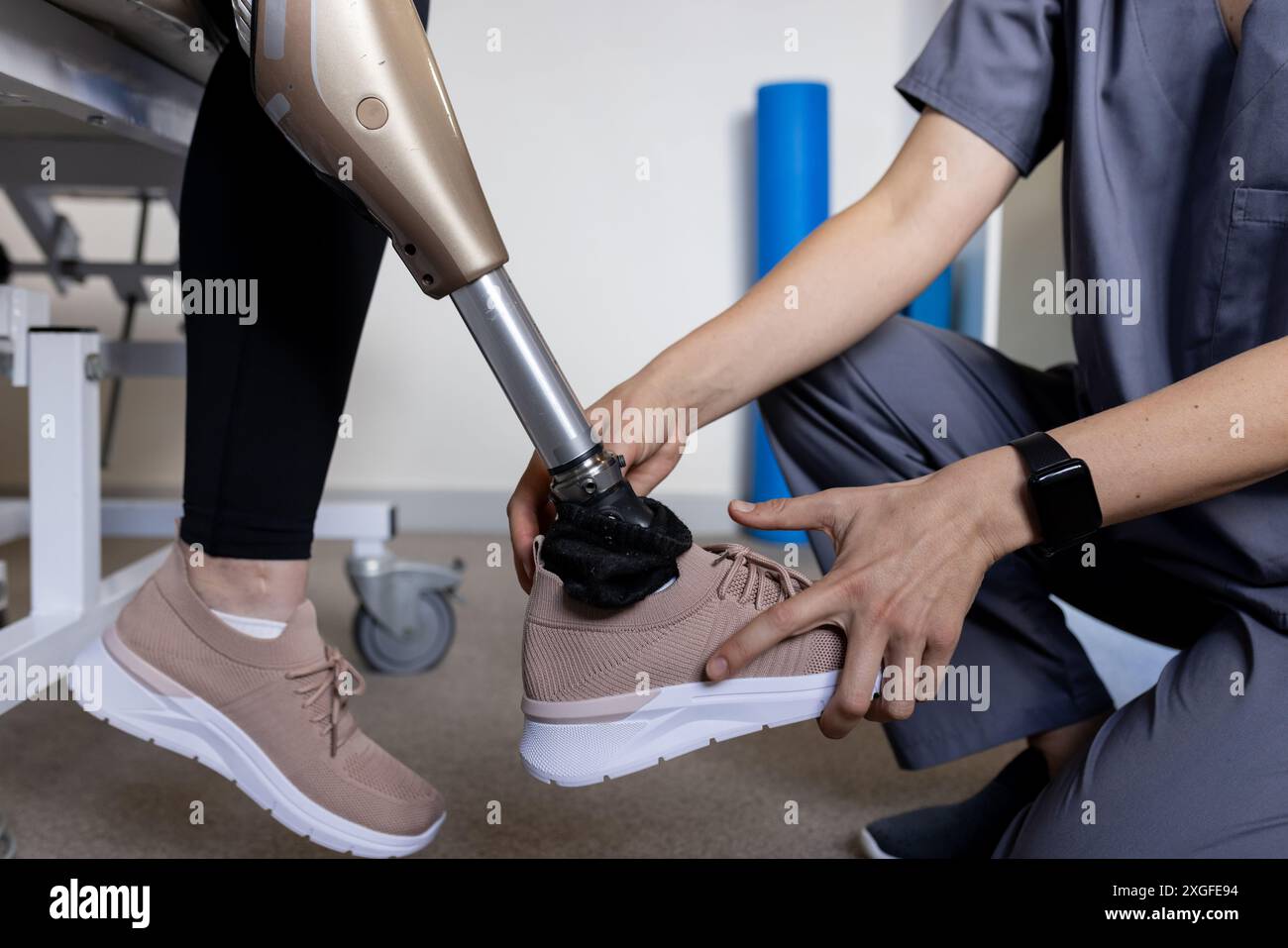 Adjusting prosthetic leg, healthcare professional fitting shoe for ...