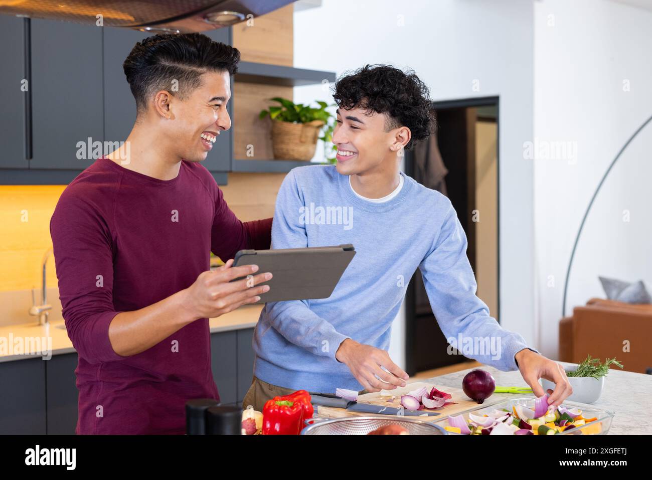 Gay couple cooking together hi-res stock photography and images - Alamy