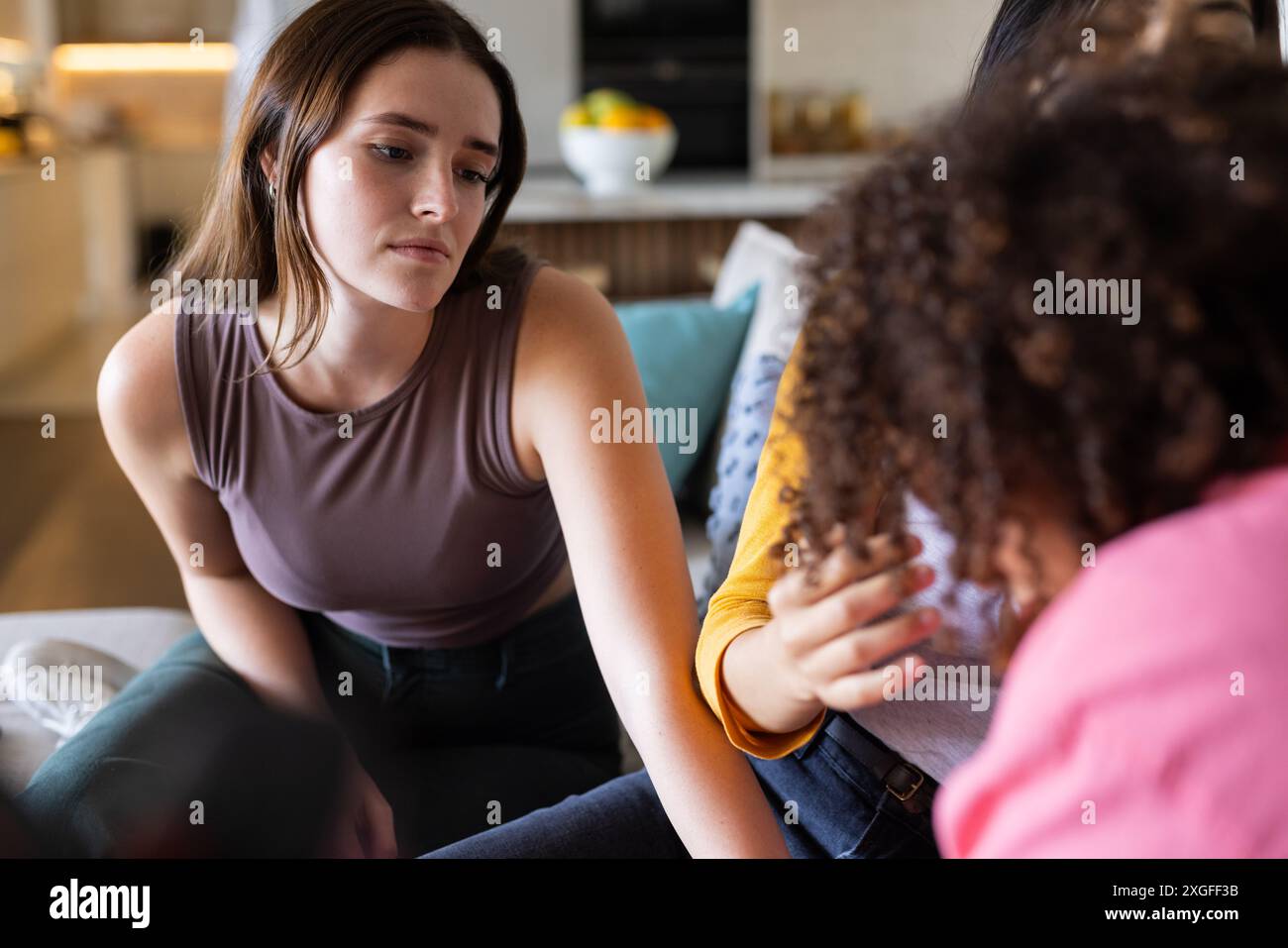 Woman comforting friend on couch hi-res stock photography and images ...