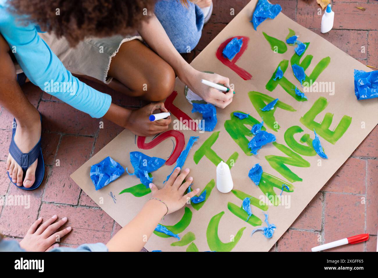 Close up of diverse schoolchildren making ecology posters during ...