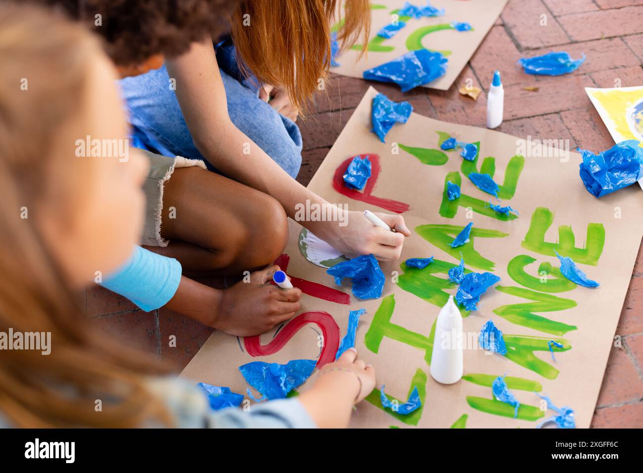 Close up of diverse schoolchildren making ecology posters during ...