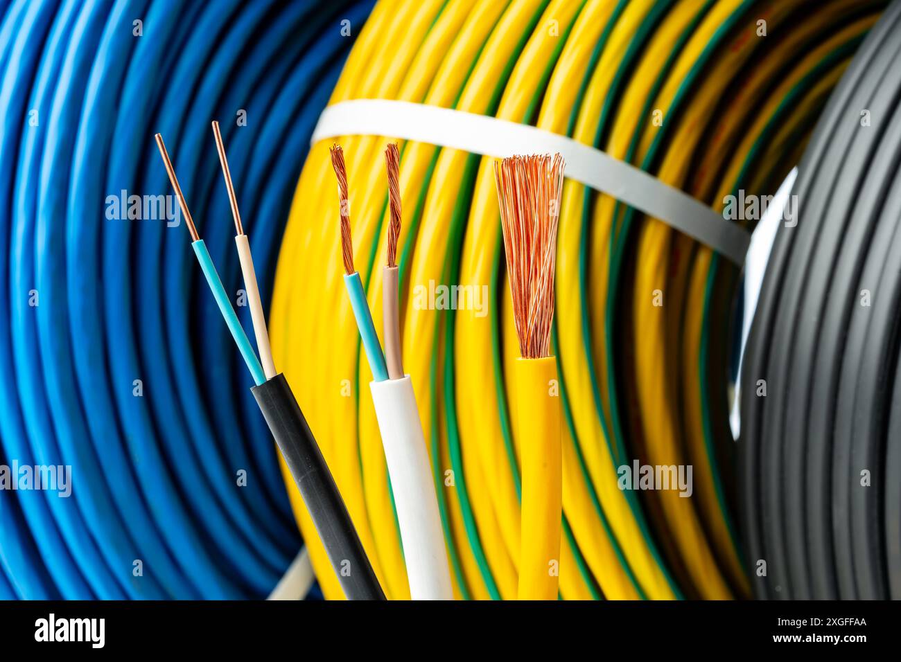 Closeup of Stripped Electrical Wires Against Rolled Cable Stock Photo ...