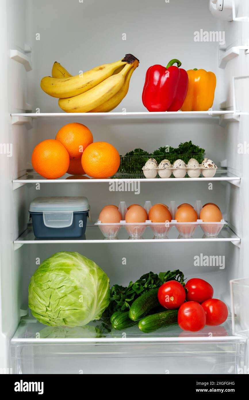White Refrigerator Open With Fresh Produce and Dairy Stock Photo - Alamy