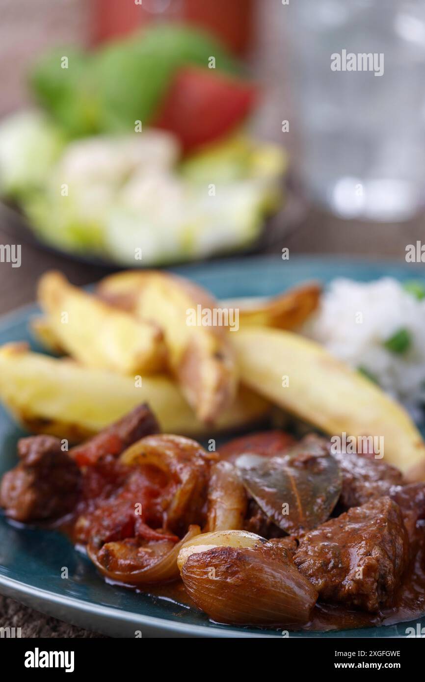 Greek stifado meat stew with chips Stock Photo - Alamy