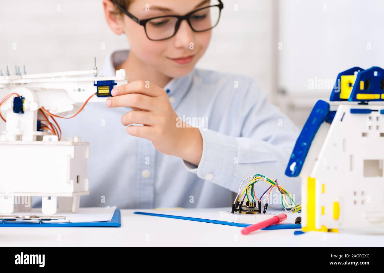 Young Boy Building Robotics Project With Wires and Circuit Board Stock ...