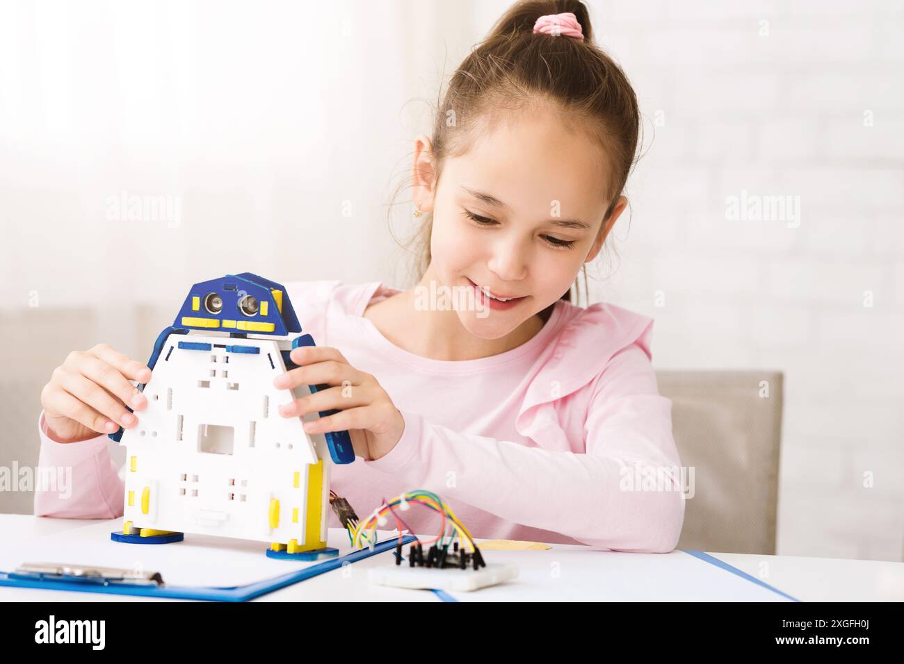 Young Girl Building a Robot Toy at Home Stock Photo - Alamy