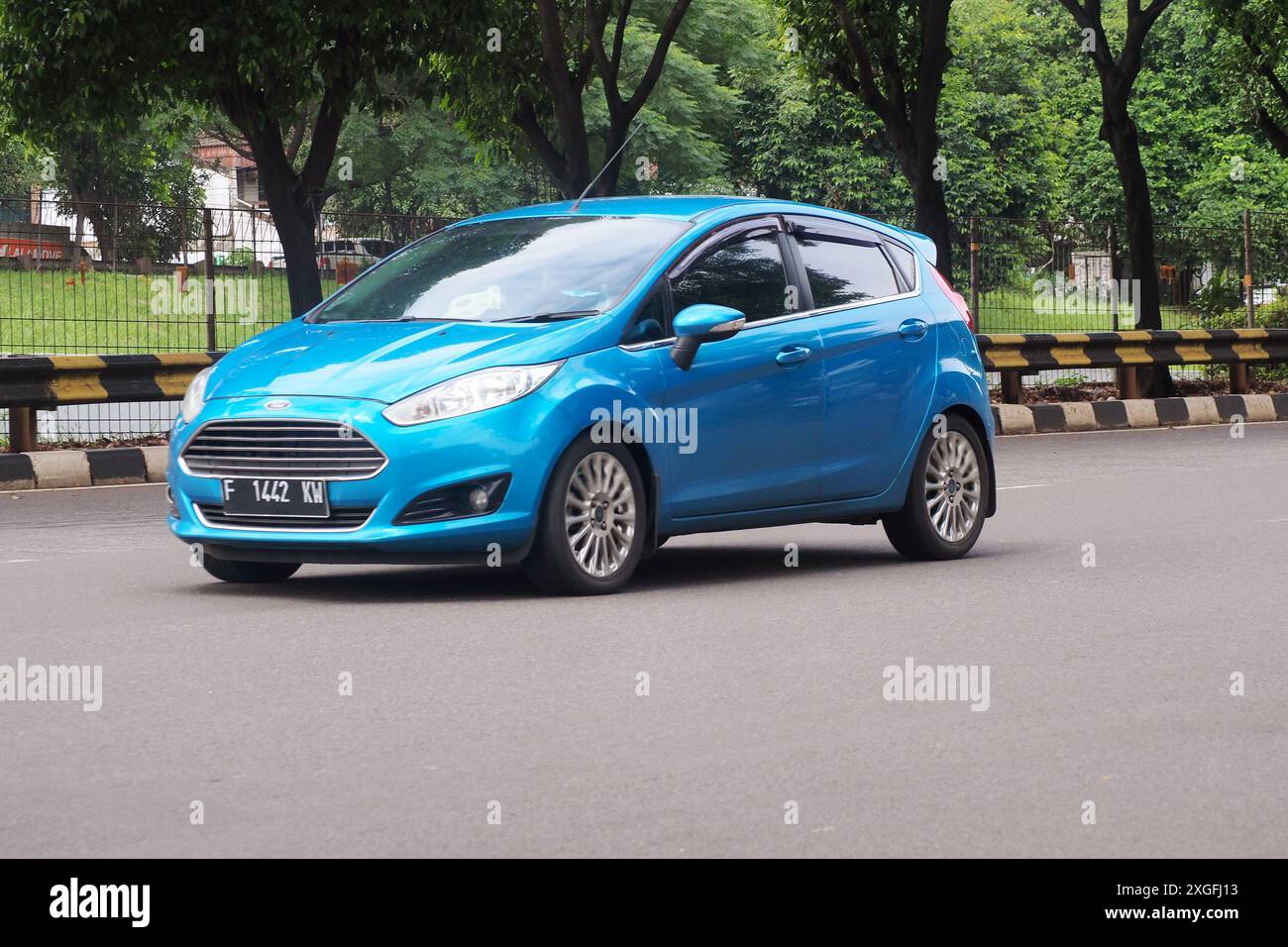 Small city car, Ford Fiesta blue color, drive in TB Simatupang street ...