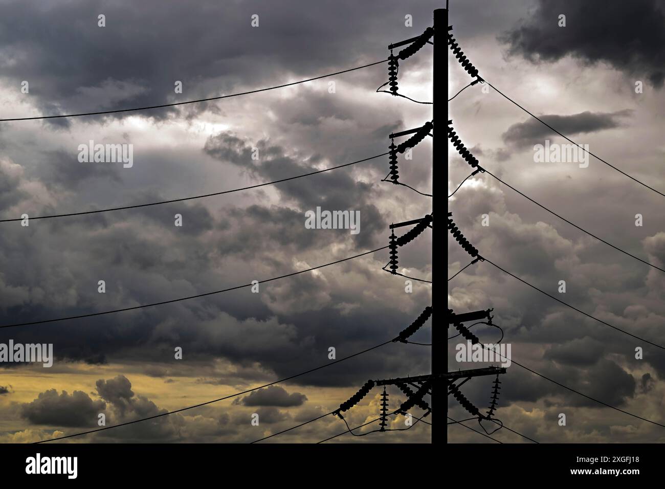 Electricity pylons and storm clouds Stock Photo - Alamy