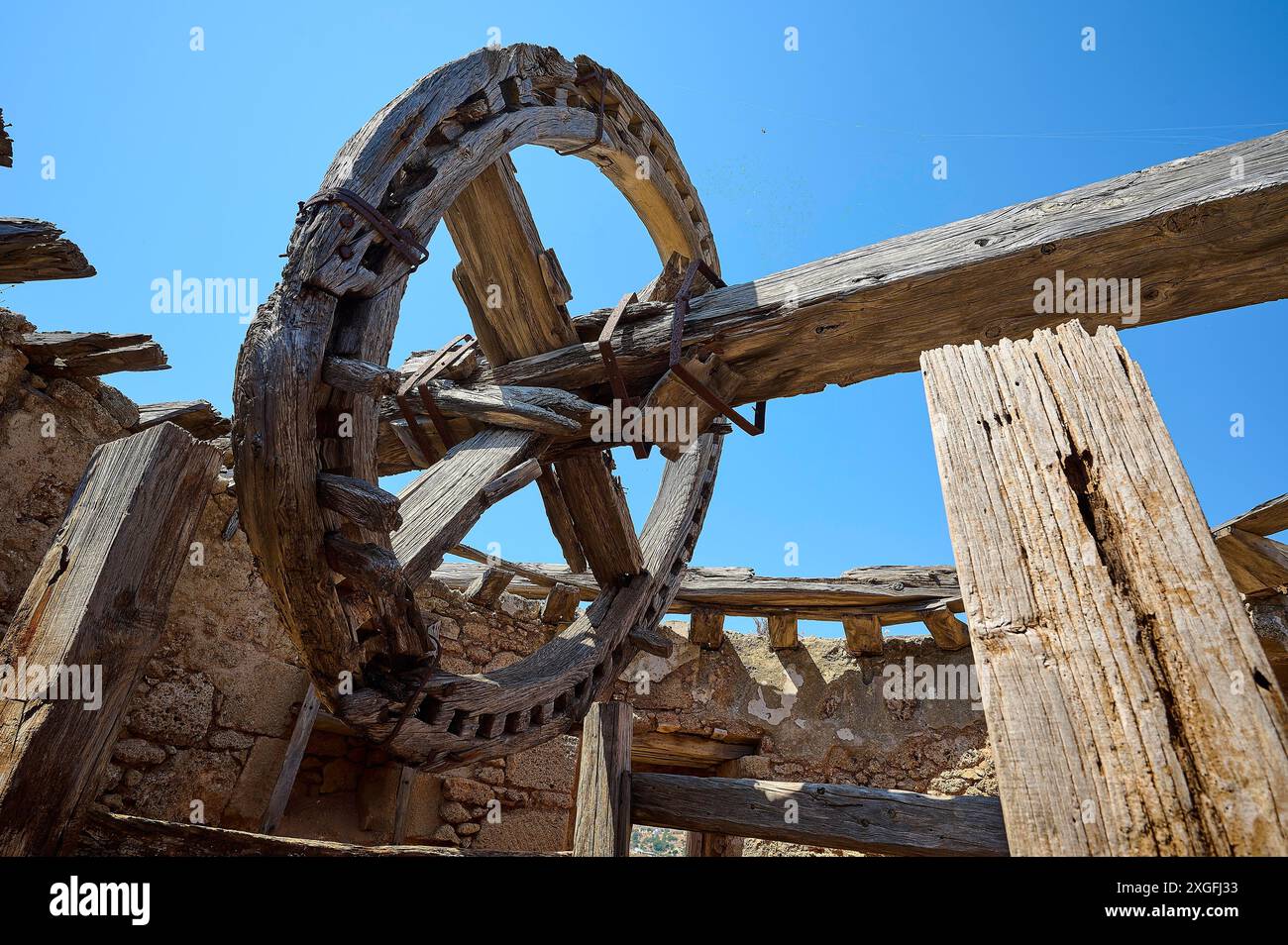 Close-up of a wooden cogwheel and wooden beams in an abandoned old mill ...