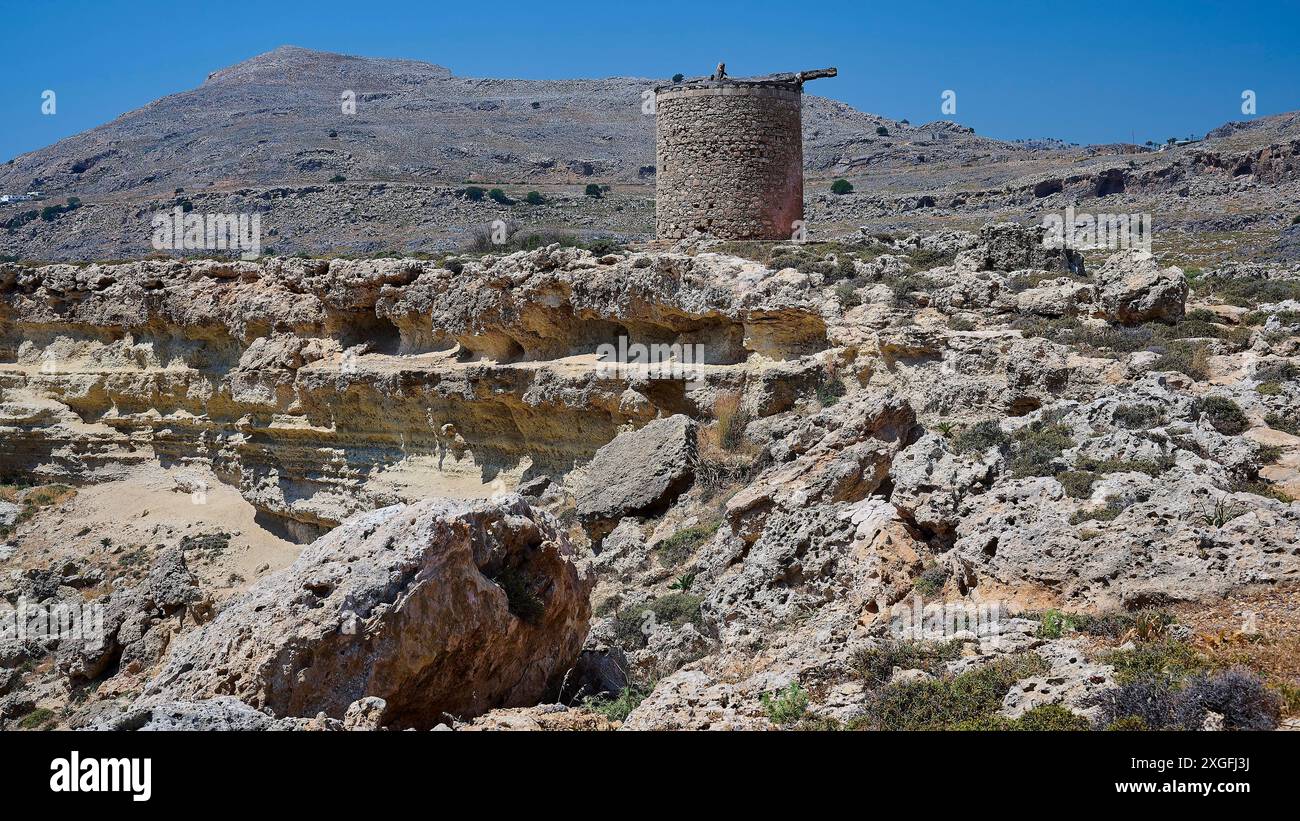 Medieval ruin on a rocky terrain with a clear blue sky, windmill, ruin ...