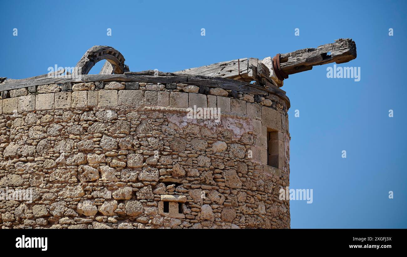 A historic round tower with stone walls and old wooden beams under a ...