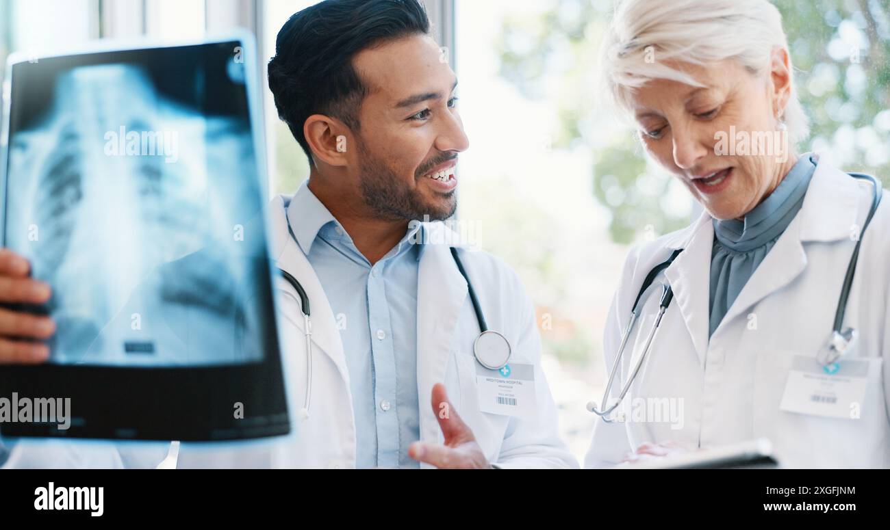 Doctors, x ray and medical discussion in hospital, professional and ...