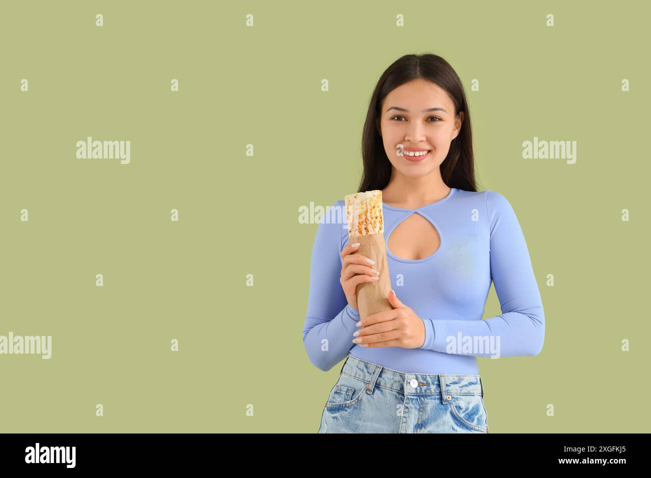 Young Asian woman with doner kebab on green background Stock Photo - Alamy