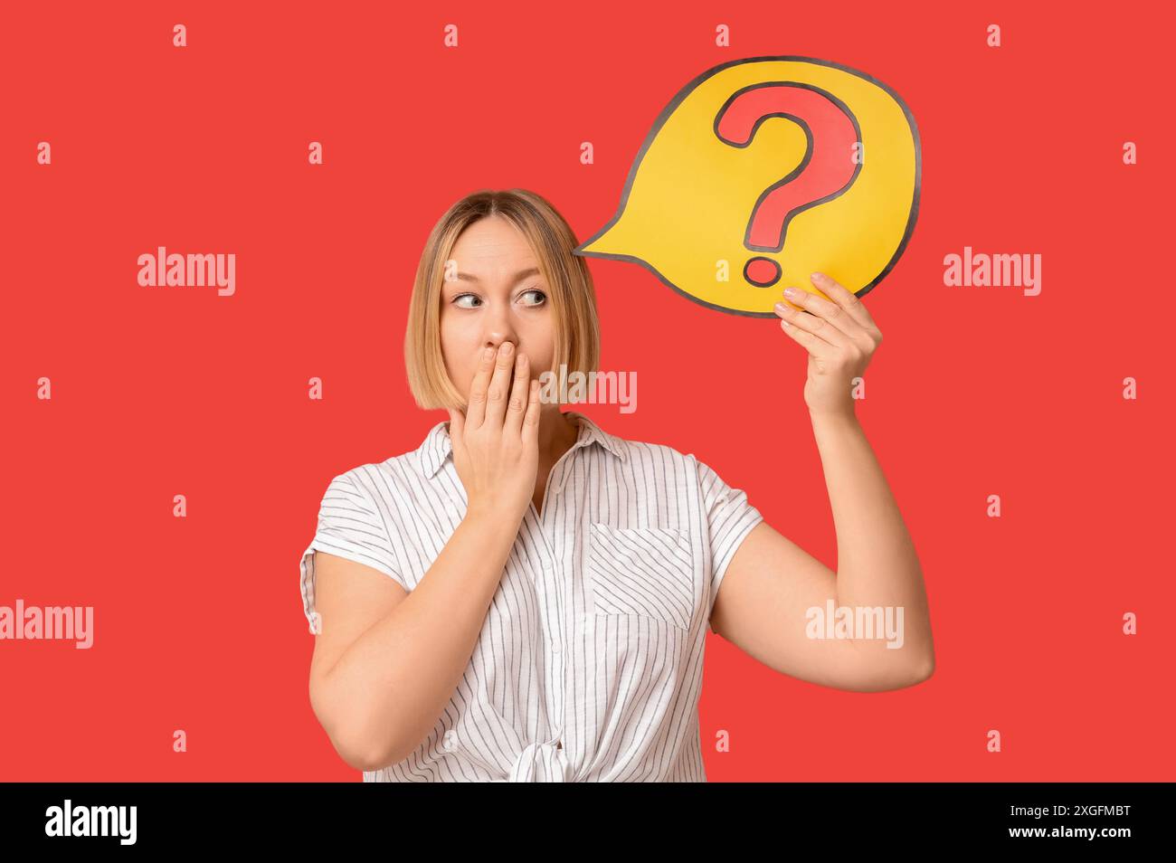 Shocked adult woman holding speech bubble with question mark on red ...