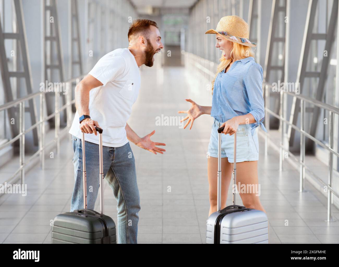 Couple arguing at airport terminal, side view Stock Photo - Alamy