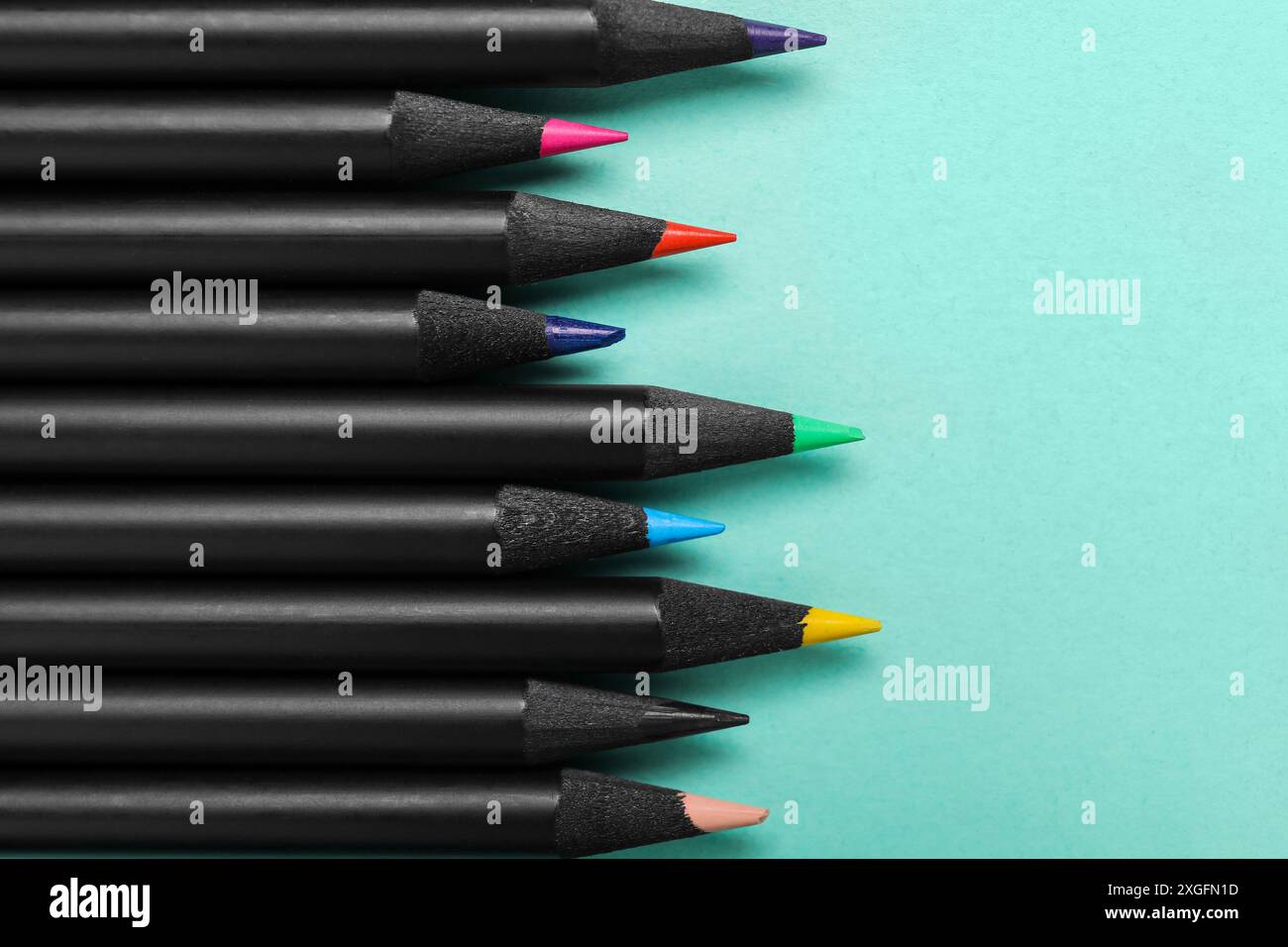 Color pencils on turquoise background, closeup Stock Photo - Alamy