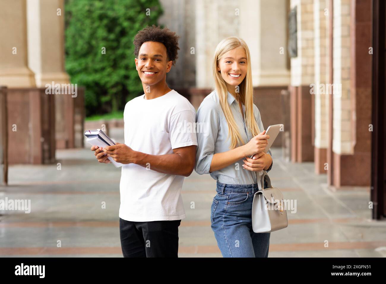 Diverse students resting in university campus, having break Stock Photo ...