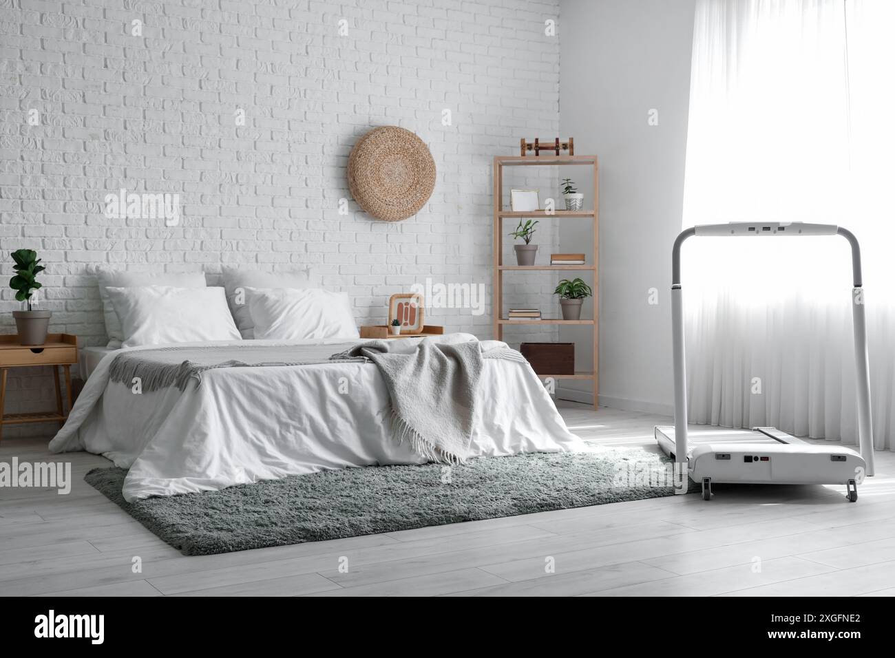 Interior of light bedroom with treadmill and shelf unit Stock Photo - Alamy