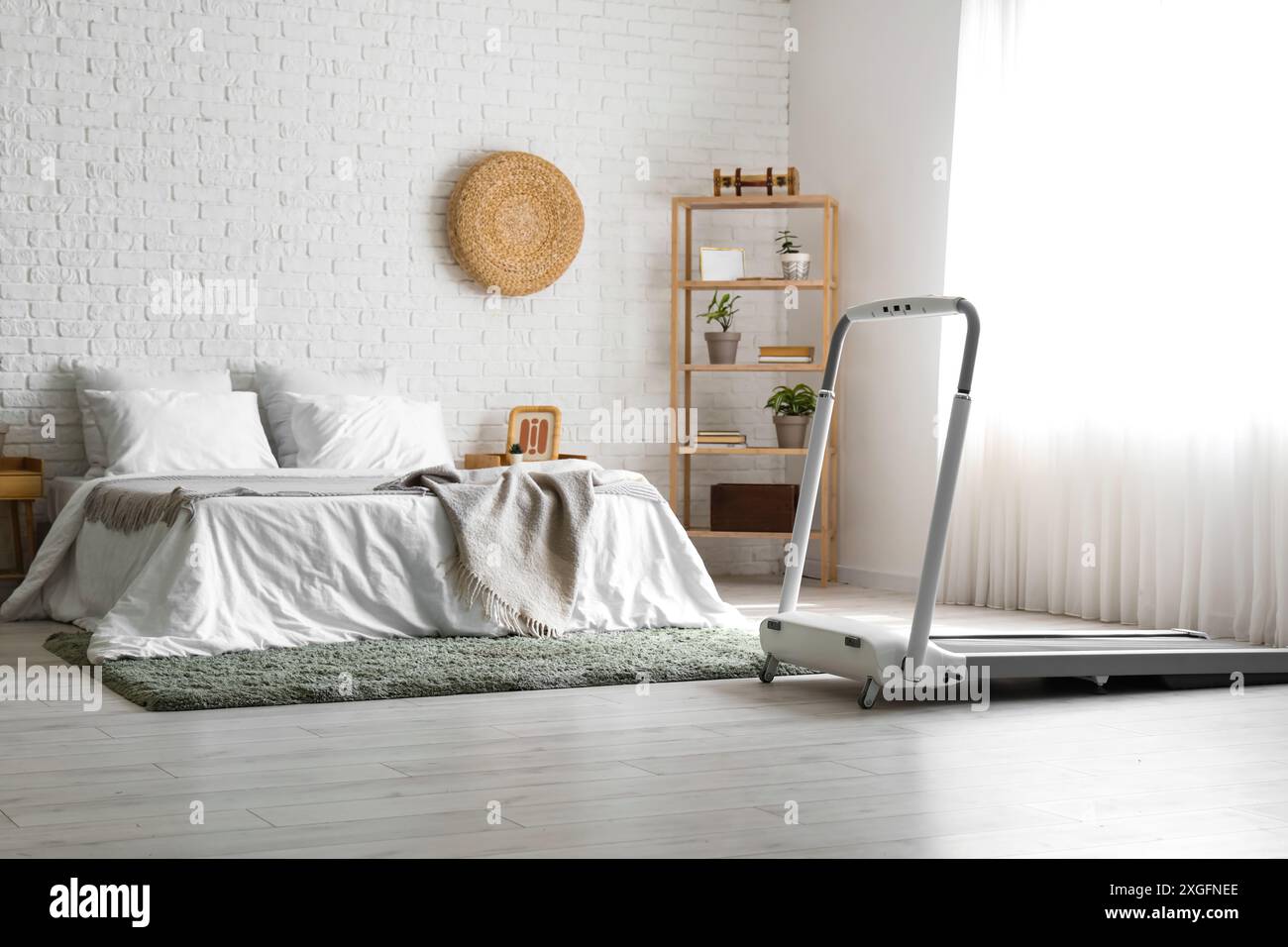 Interior of light bedroom with treadmill and shelf unit Stock Photo - Alamy