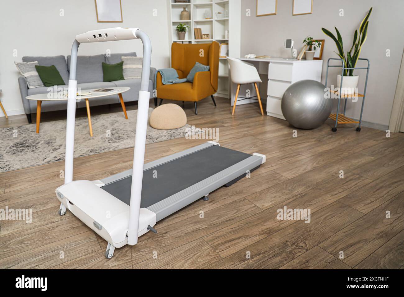 Modern treadmill in interior of living room Stock Photo - Alamy