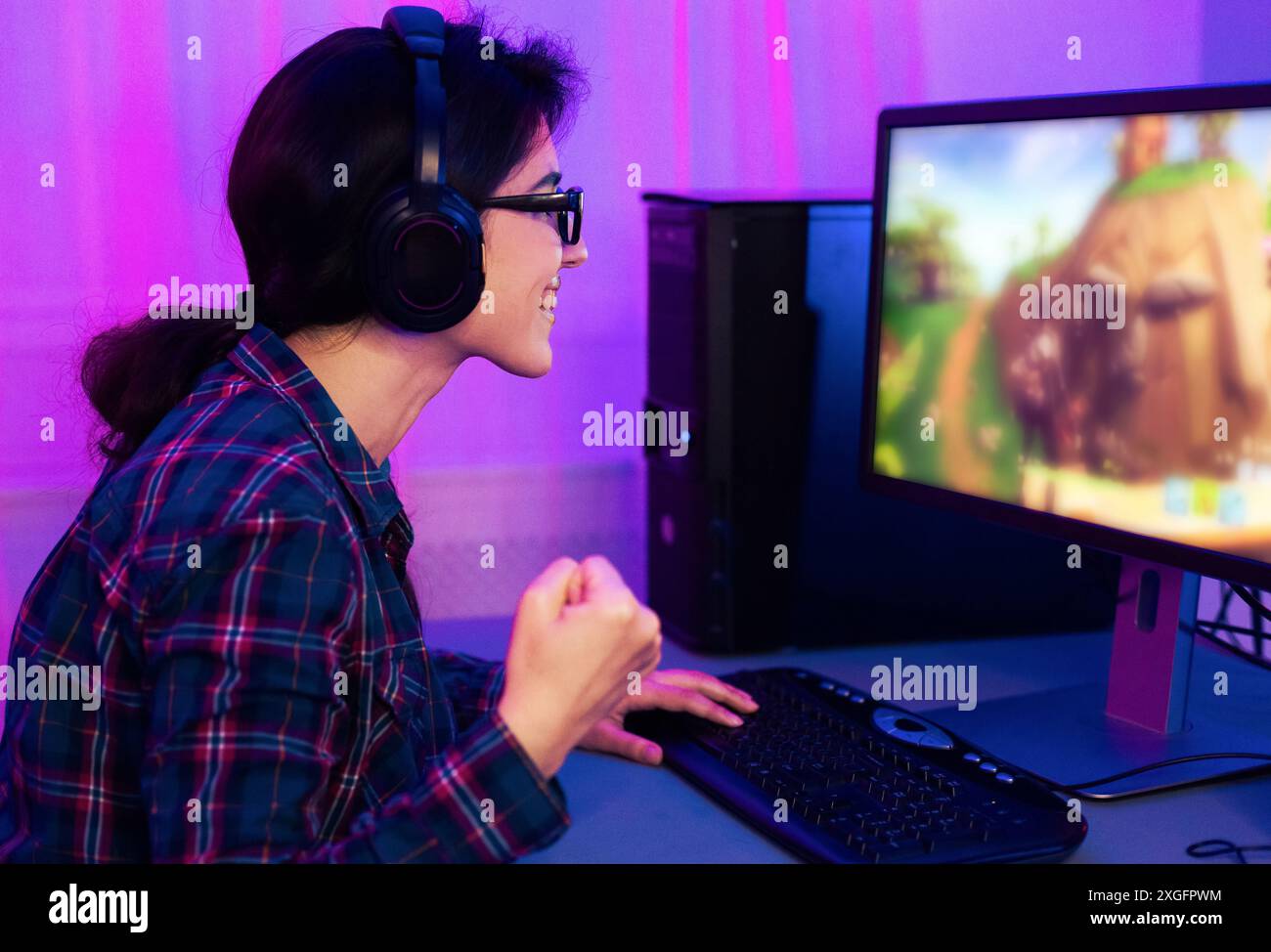 Woman Gaming in a Purple Room With a Computer Monitor Stock Photo - Alamy