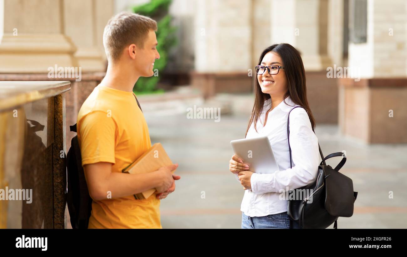 Classmates talking in college campus during break Stock Photo - Alamy