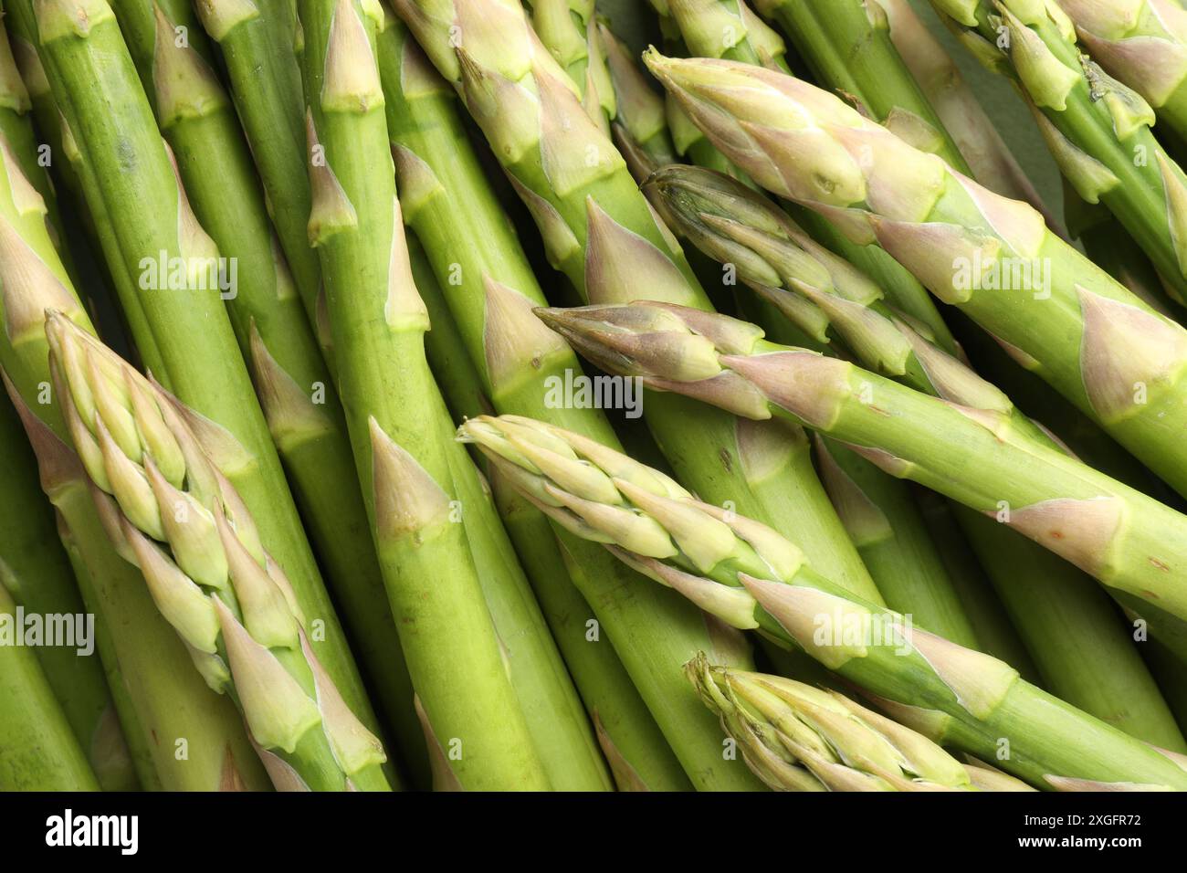 Fresh green asparagus stems as background, top view Stock Photo - Alamy