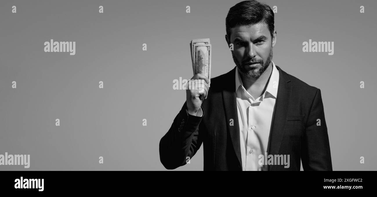 Man holding cash money in dollar banknotes on isolated gray background ...