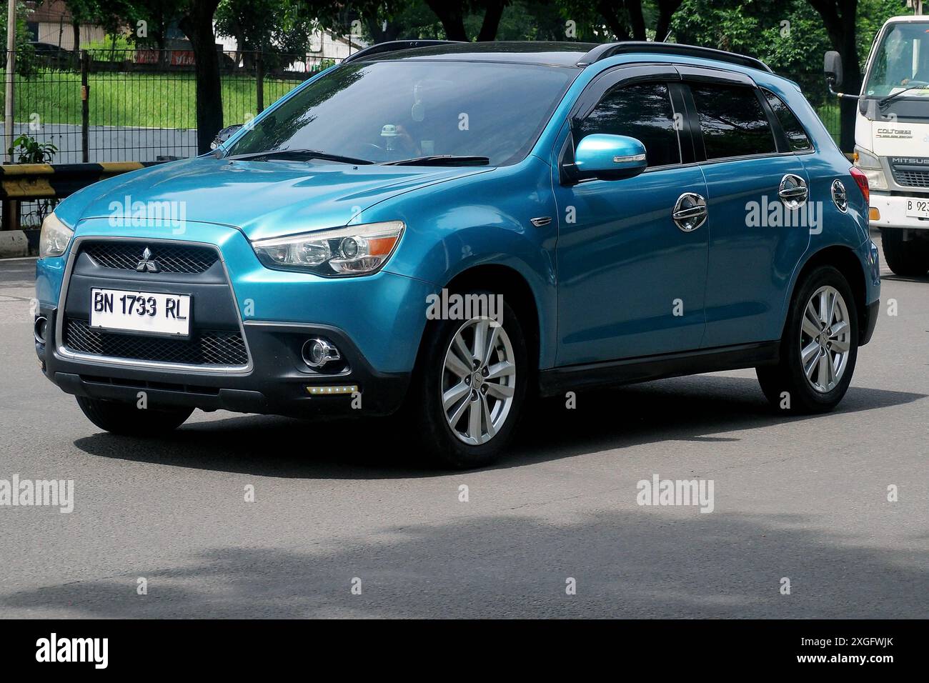 Blue color Mitsubishi Outlander car, driving at TB Simatupang street ...
