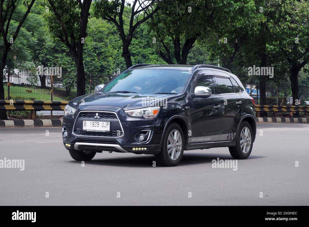 dark color Mitsubishi Outlander car, driving at TB Simatupang street ...