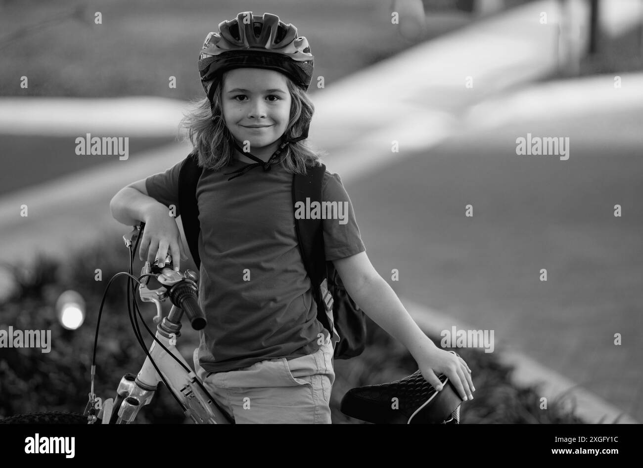 Little kid boy riding a bike in summer park. Child drive a bike on a ...