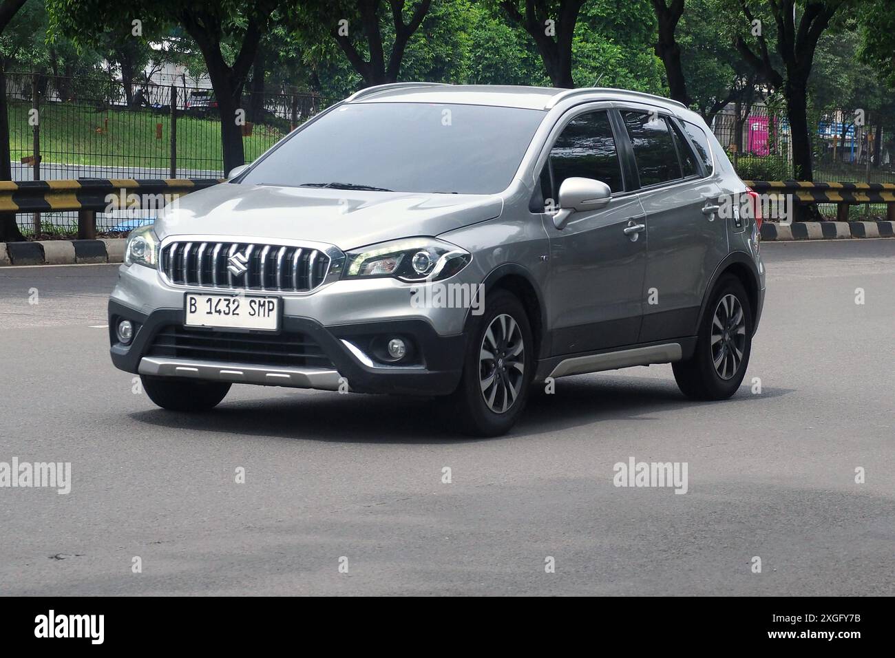 dark gray color SUV Suzuki Baleno car, driving at TB Simatupang street ...