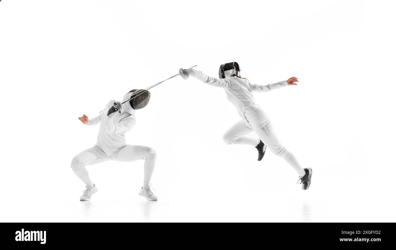 Fencing partners engage in mock duel, focusing on improving their ...