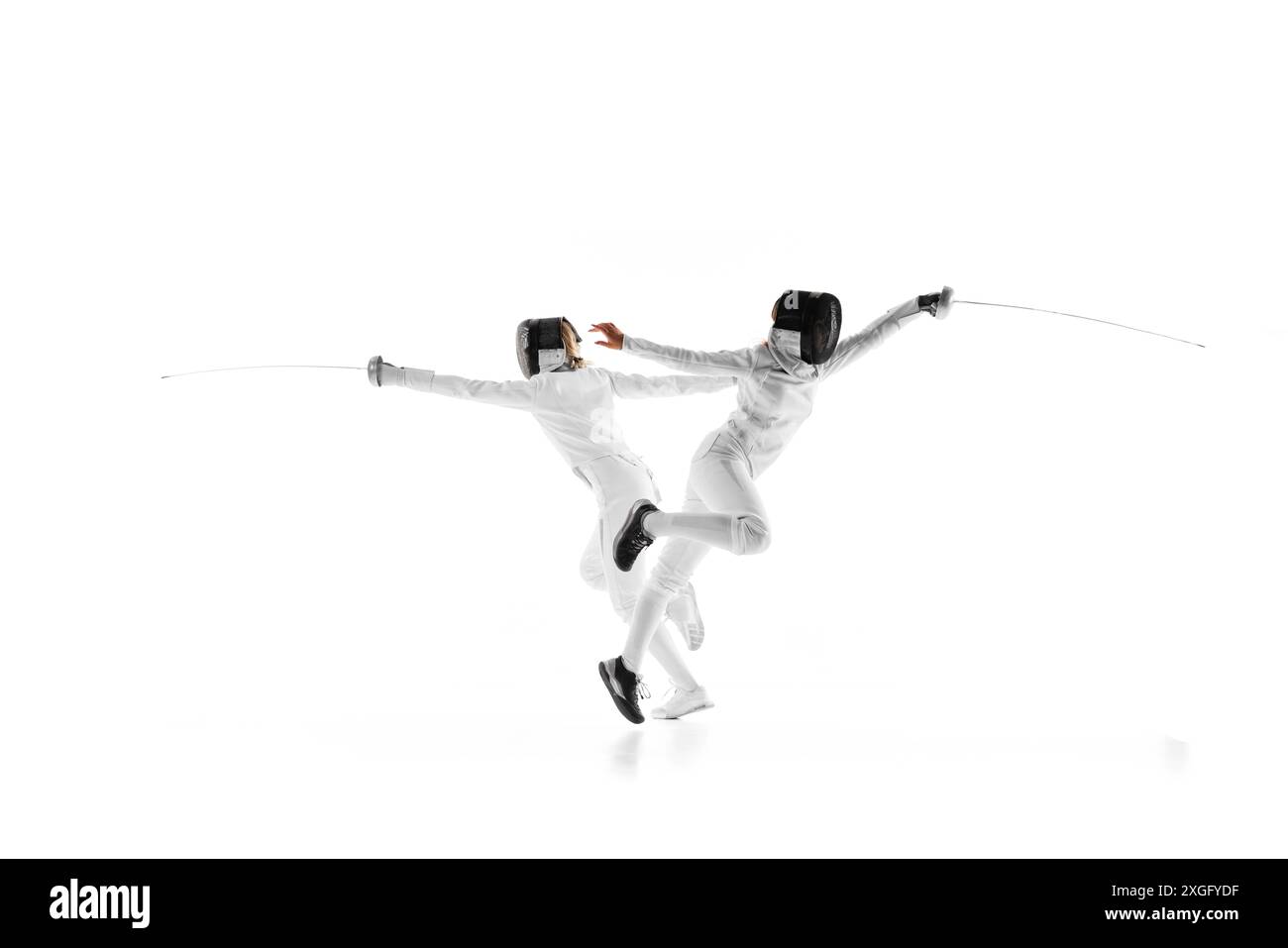 During fencing drill, two athletes test their skills against each other ...