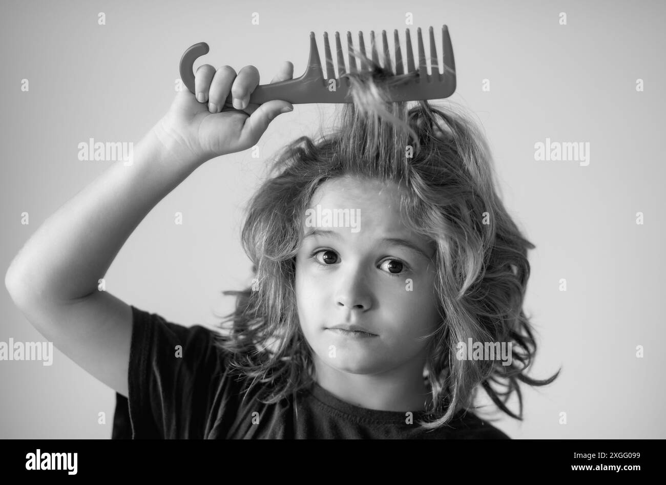 Haircare and kids hair styling. Kid boy makes face expressions, combing ...
