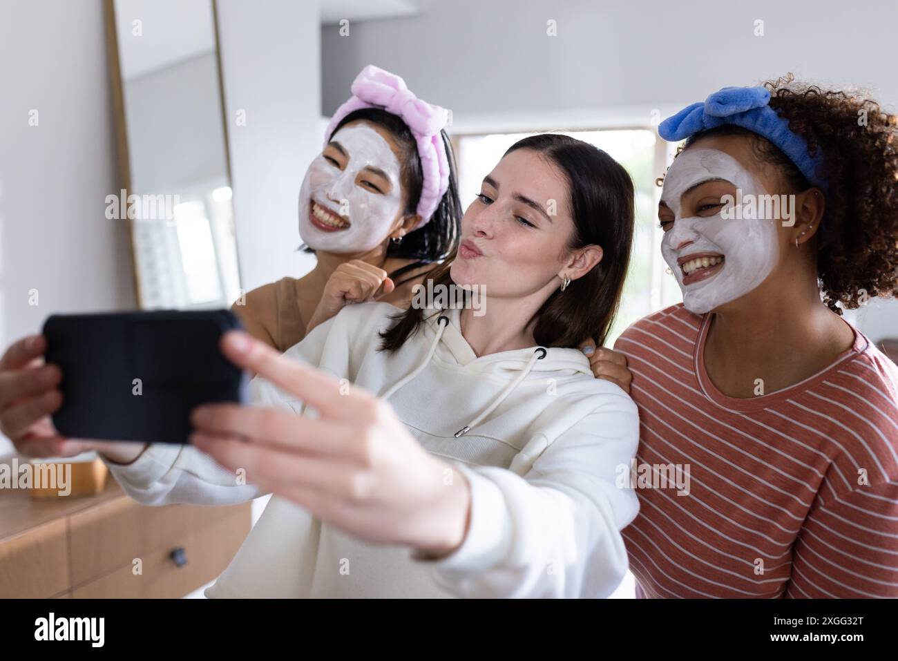 Taking selfie, three women friends with face masks enjoying time ...