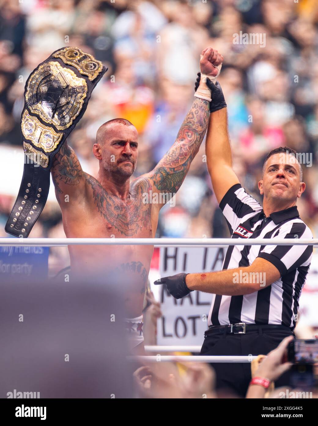 CM Punk holding championship belt after victory at AEW All In, Wembley ...