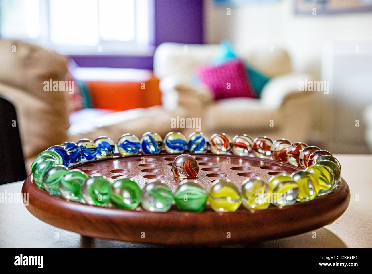 Solitaire marbles wooden board game, colourful marbles, selective focus ...