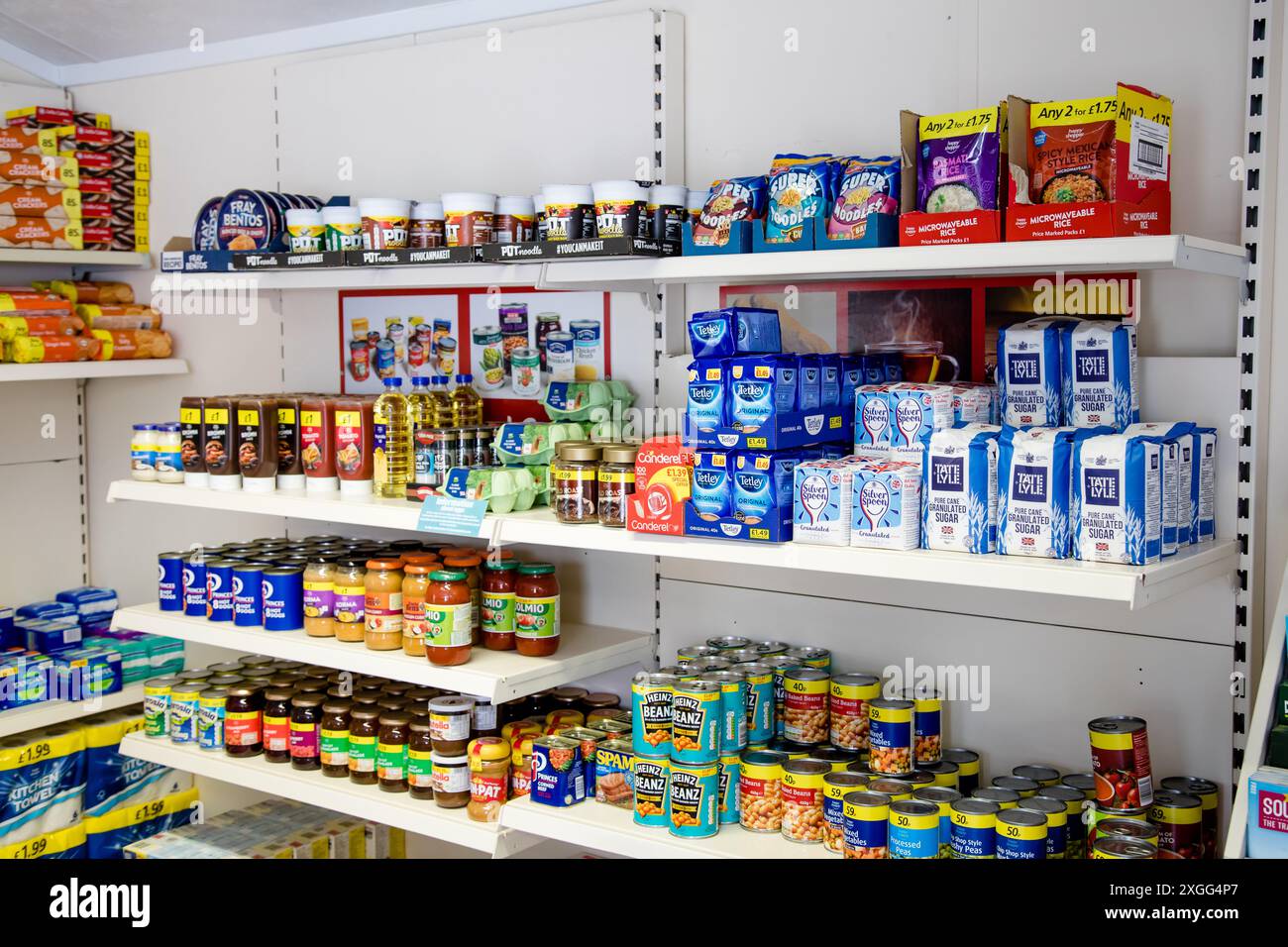 Shelves full of food and tins at a foodbank Stock Photo - Alamy