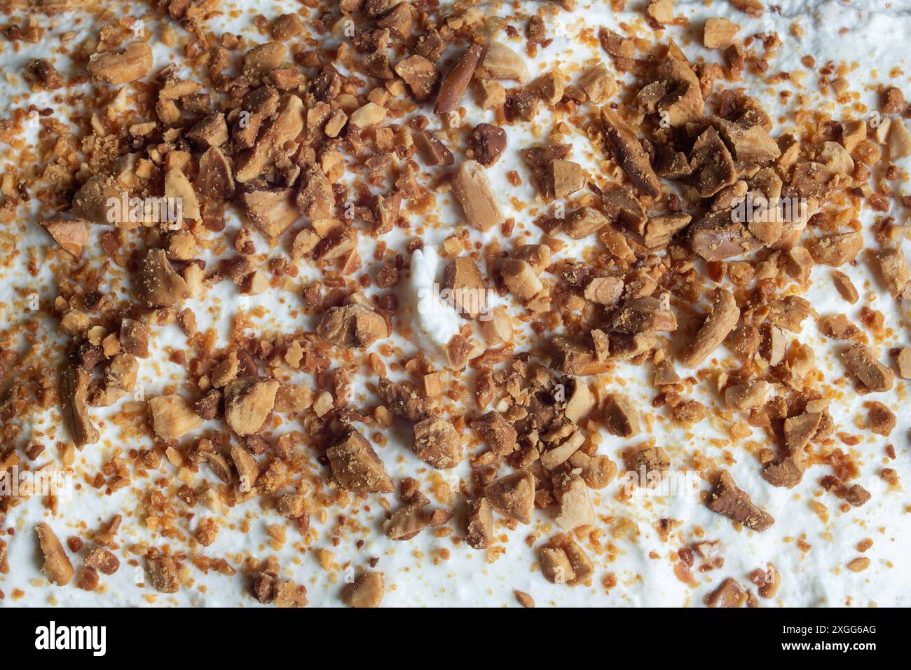 Close-up of a detailed texture of roasted almonds scattered on a ...