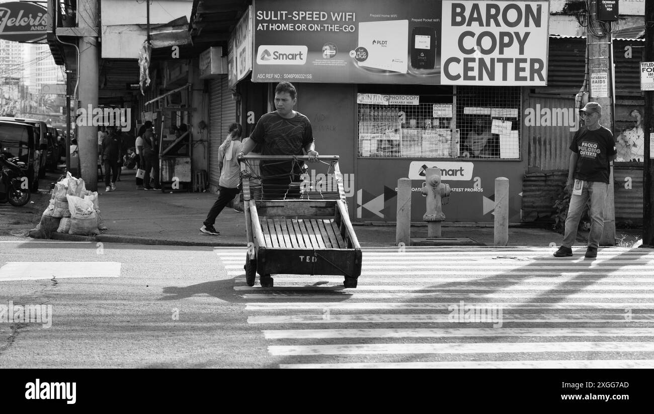 A man pushing a cart with a sign that says "Baron Copy Center" behind ...