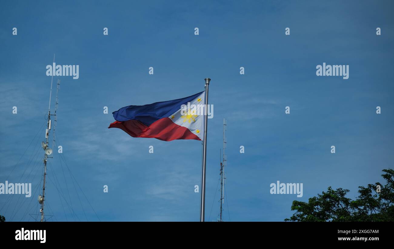 A flag with the colors red, white, and blue is flying in the sky Stock ...