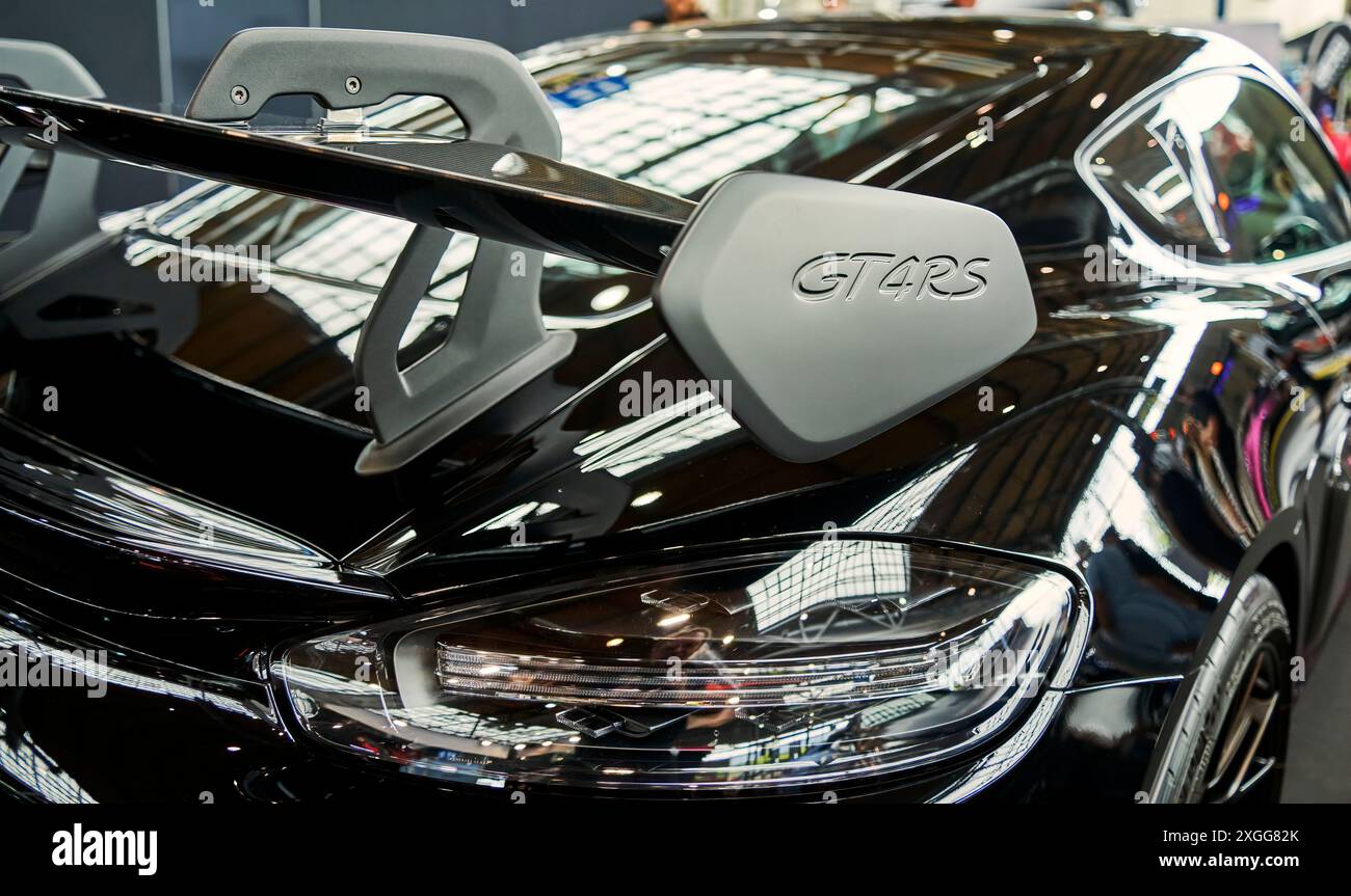 Porsche GT4 RS, rear view of the black sports car with large rear wing ...