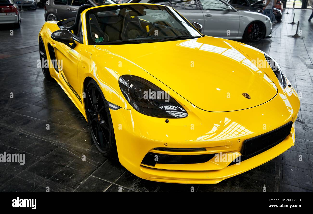 Porsche 718 Boxster Cabrio with open top in bright yellow paint in ...