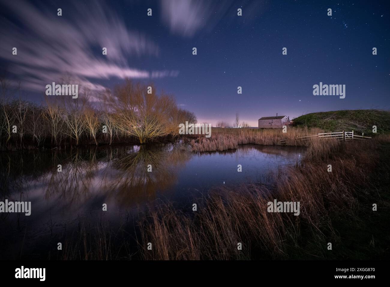Shepherd Hut and pond at night illuminated by moonlight, Elmley Nature ...