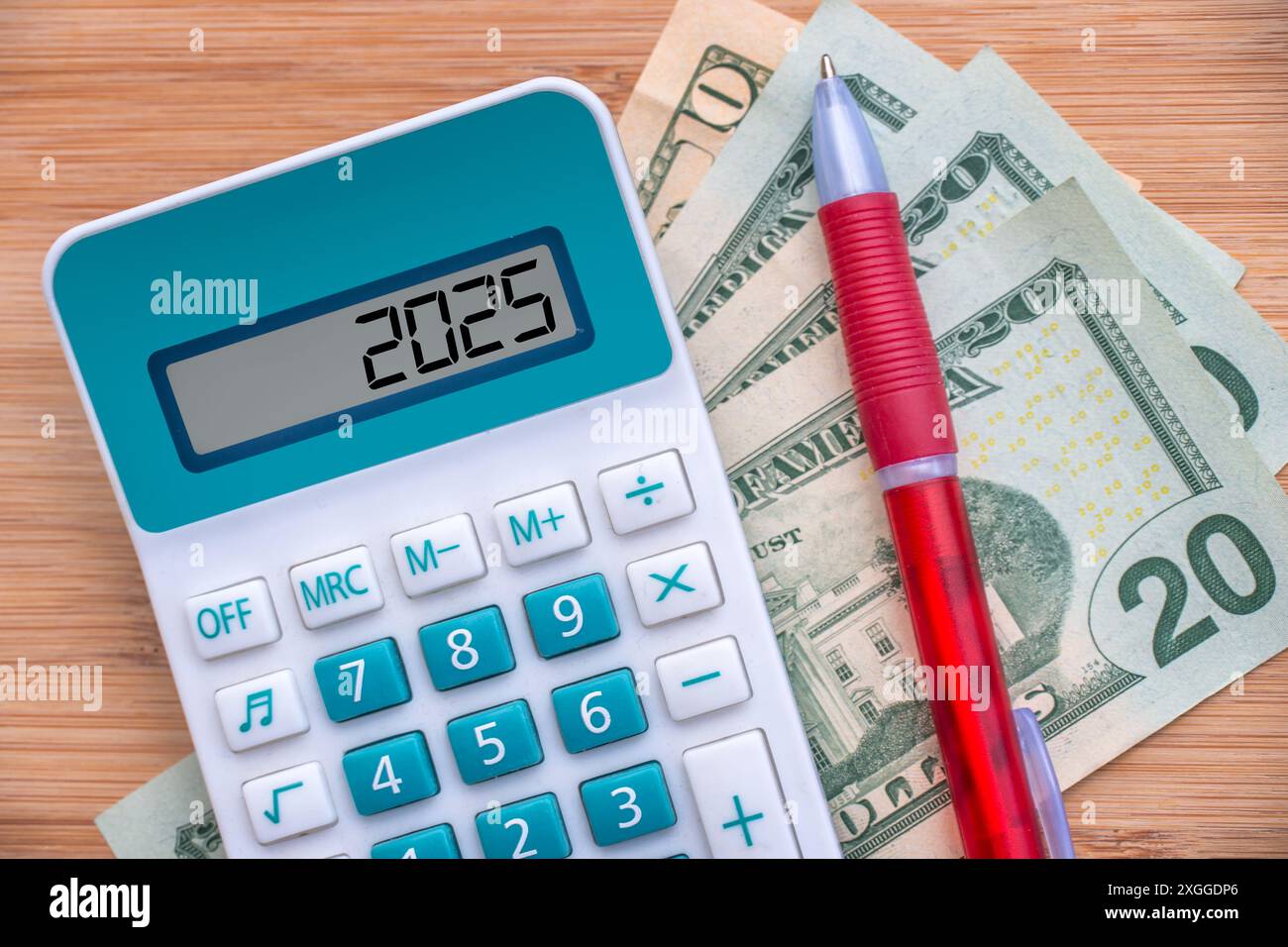 2025 numbers on a calculator and dollars banknotes, new year finance ...