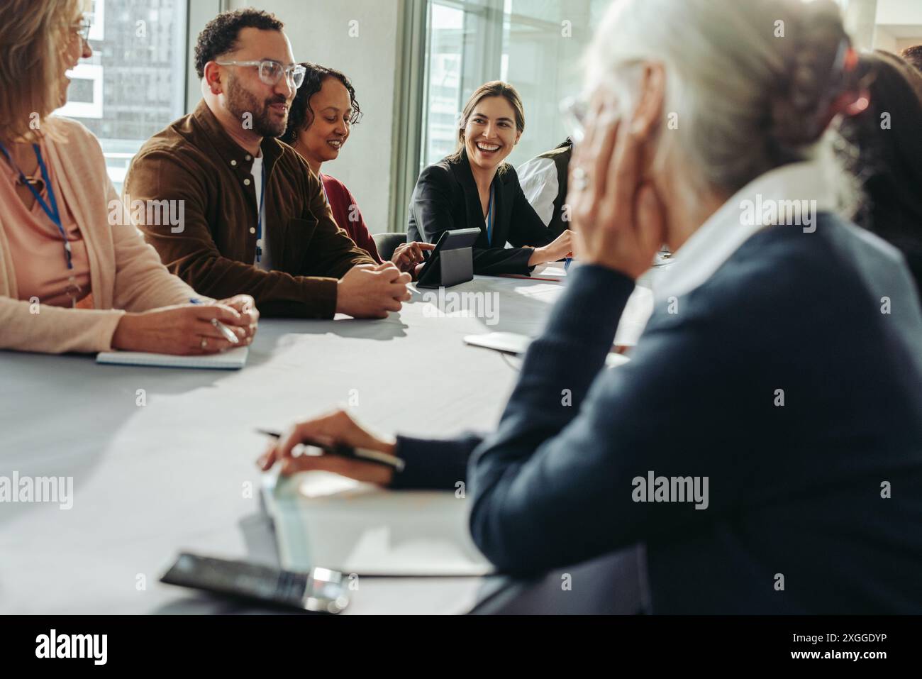 Diverse group of people engaged in a business meeting, discussing ideas ...