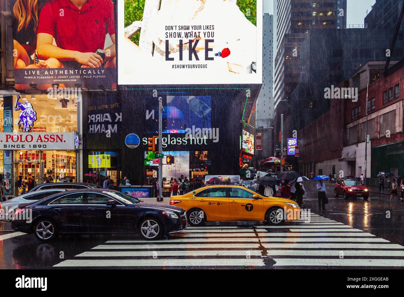 Yellow Taxi and Traffic on Times Square at Night During a Heavy Rain ...