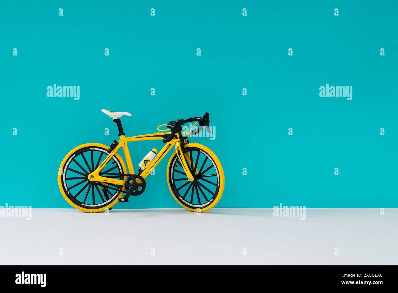 Trendy sport composition made of yellow bicycle on pastel blue and grey ...