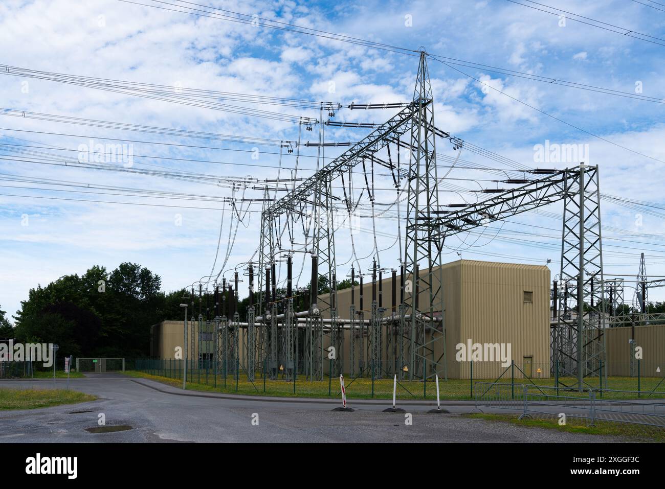A large transformer station with power lines running across a clear ...